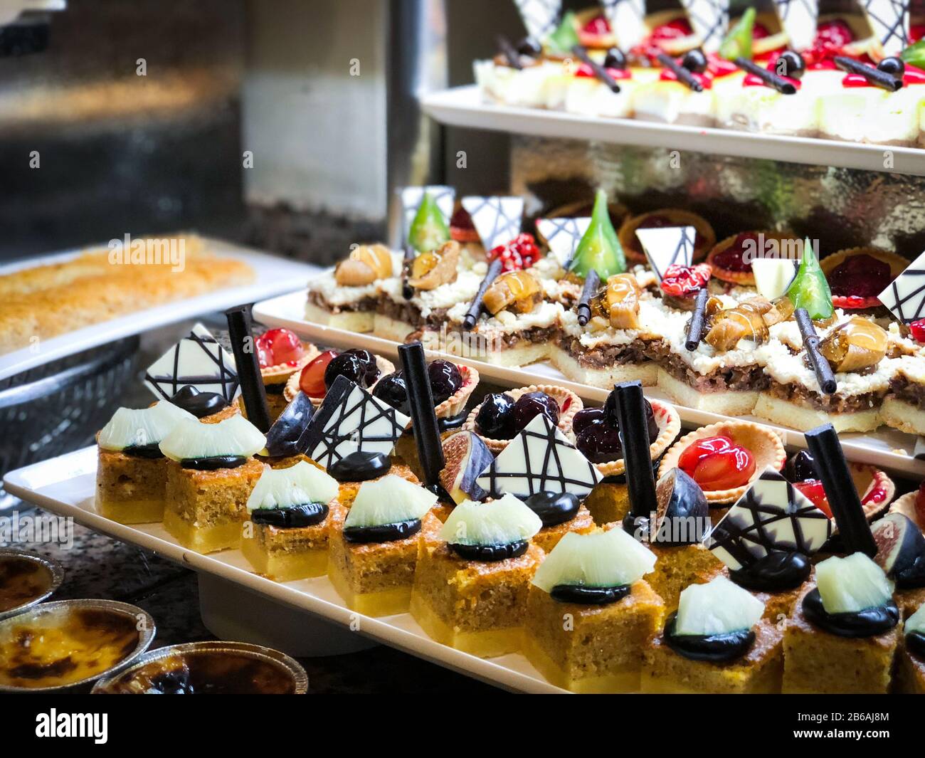 mix mini cakes & sweets with fresh fruits & glazed topping Stock Photo ...