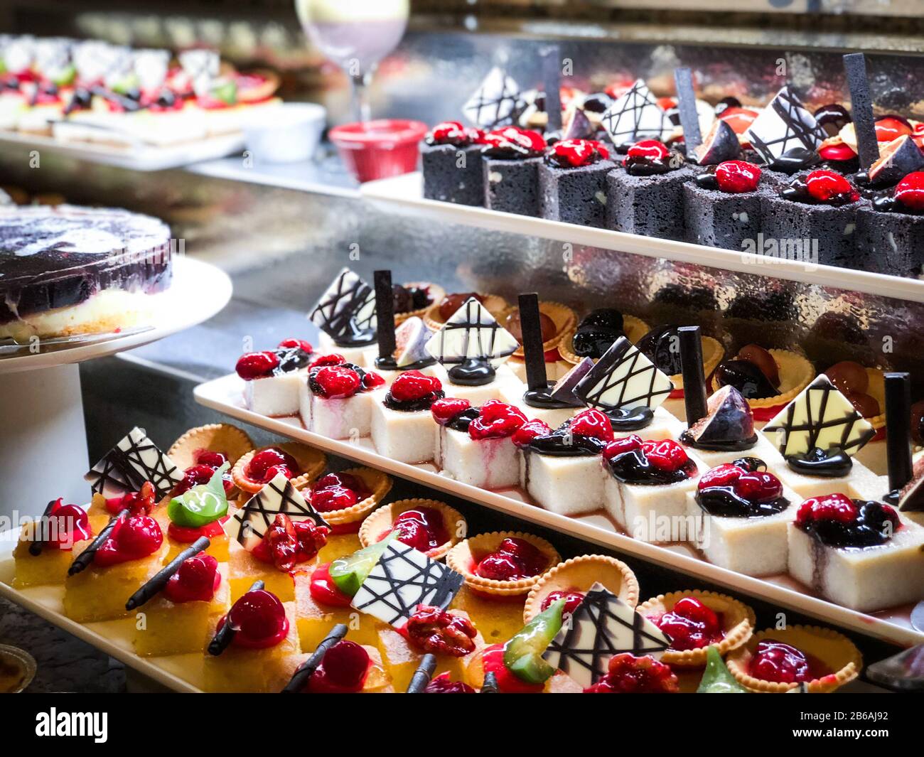 mix mini cakes & sweets with fresh fruits & glazed topping Stock Photo ...