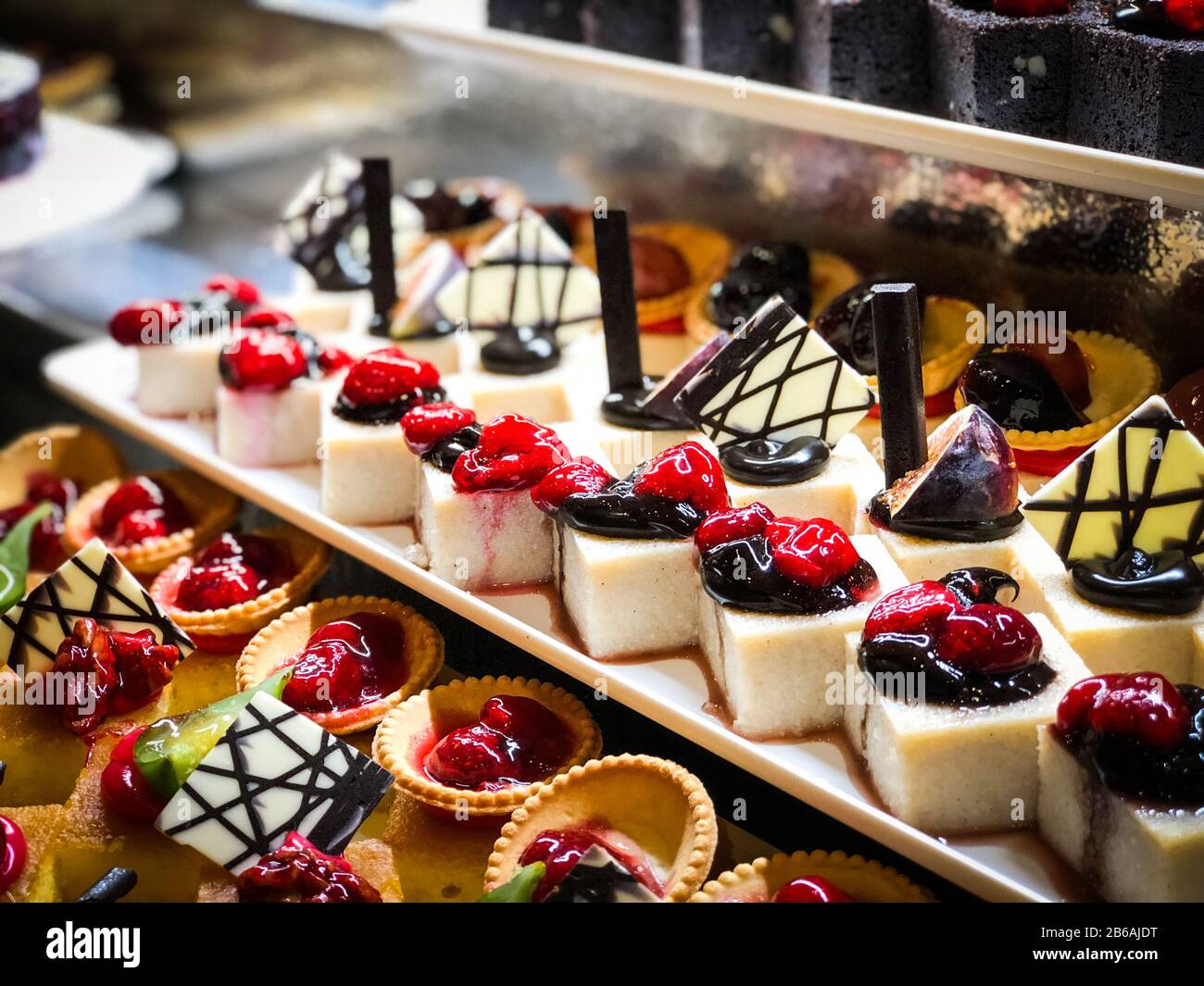 mix mini cakes & sweets with fresh fruits & glazed topping Stock Photo ...
