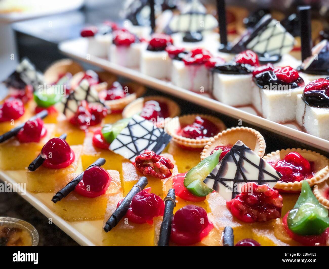 mix mini cakes & sweets with fresh fruits & glazed topping Stock Photo ...