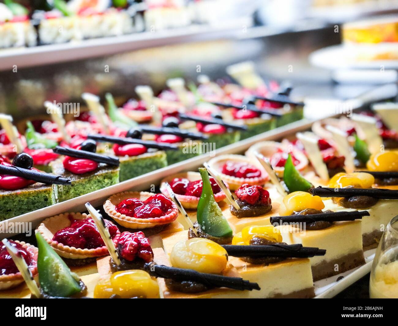 mix mini cakes & sweets with fresh fruits & glazed topping Stock Photo ...