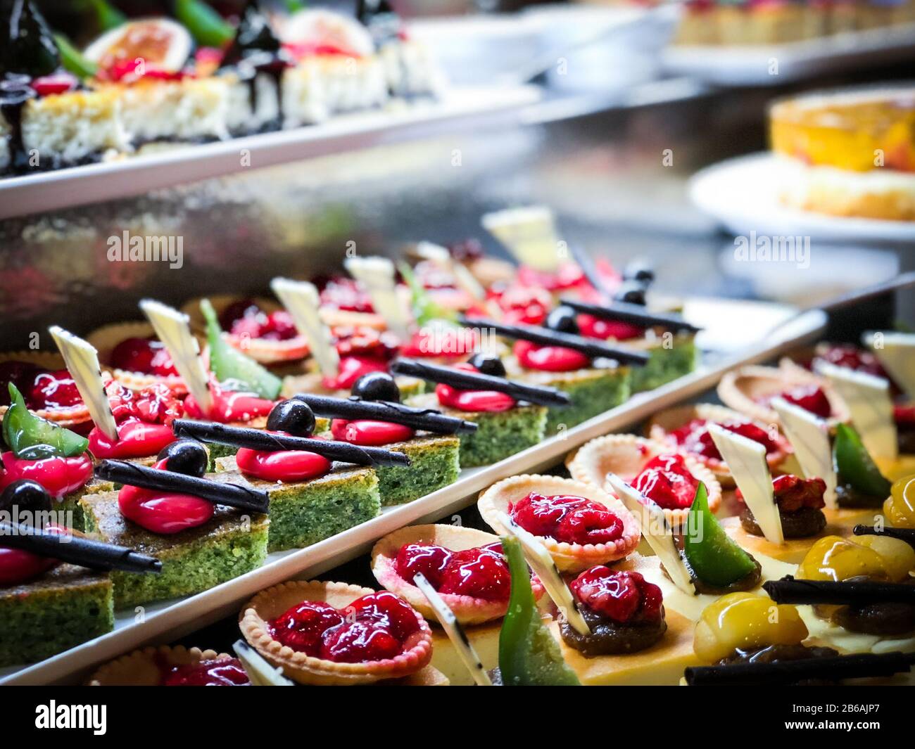 mix mini cakes & sweets with fresh fruits & glazed topping Stock Photo ...