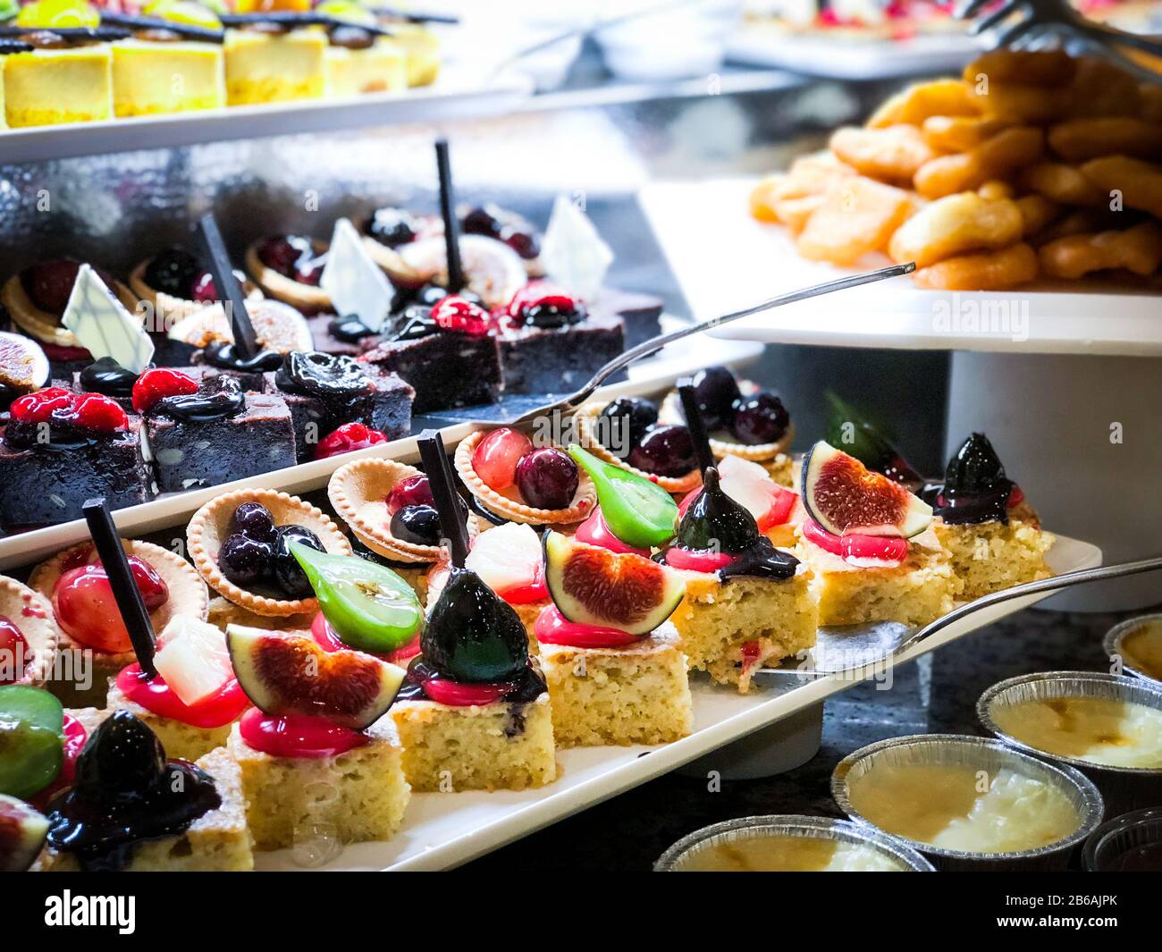 mix mini cakes & sweets with fresh fruits & glazed topping Stock Photo ...