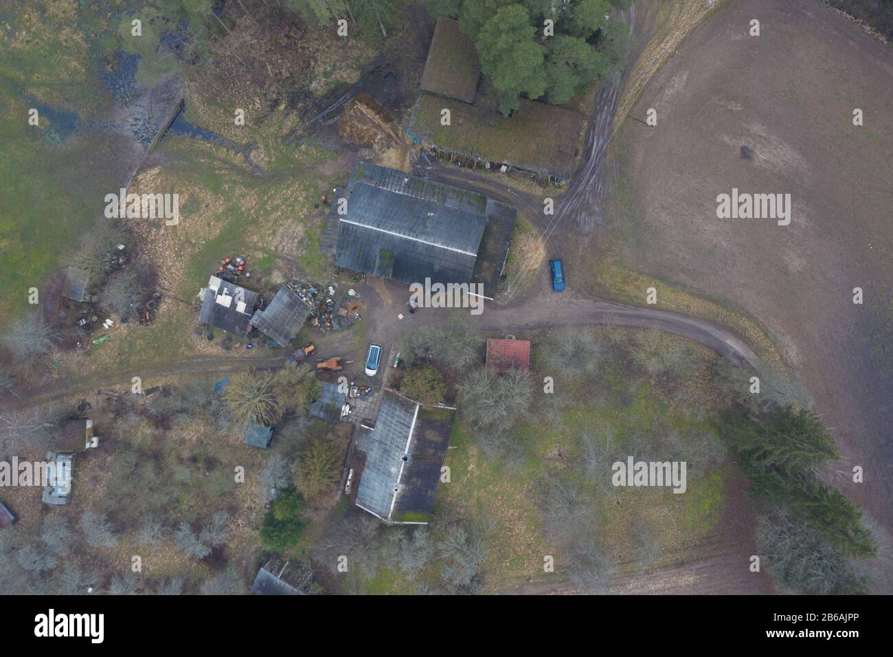 Aerial top down view of countryside farmstead house and farm buildings ...