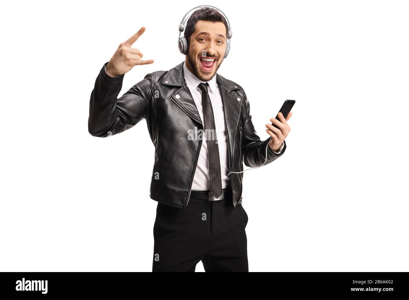 Cheerfull guy listening music with headphones and gesturing a rock and ...