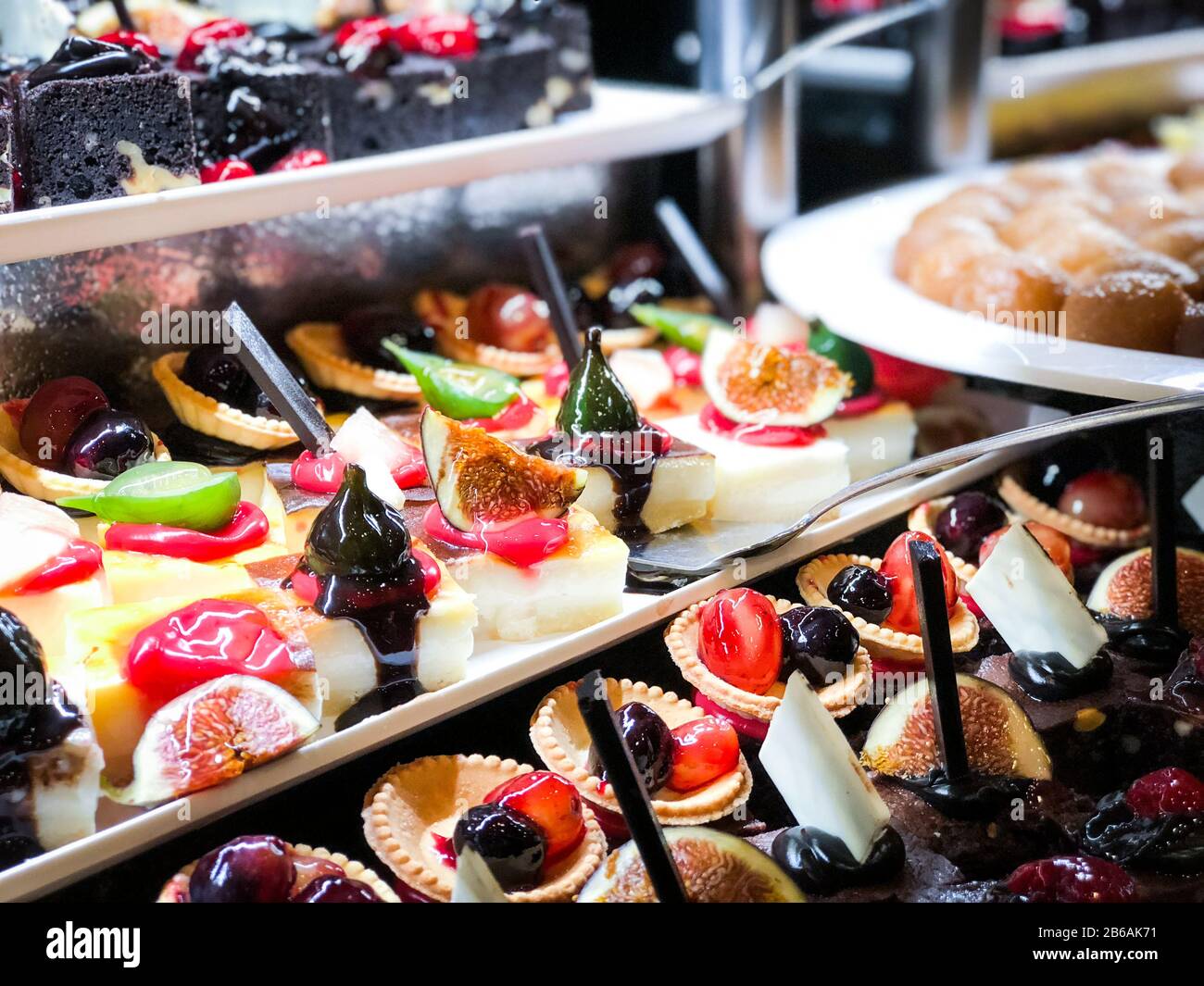 mix mini cakes & sweets with fresh fruits & glazed topping Stock Photo ...