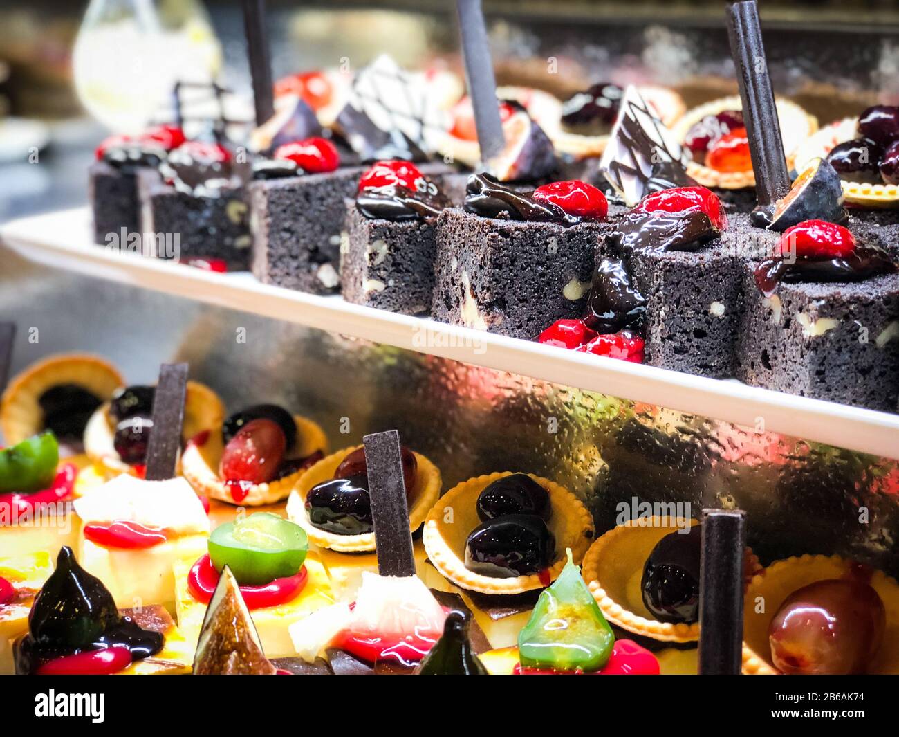 mix mini cakes & sweets with fresh fruits & glazed topping Stock Photo ...