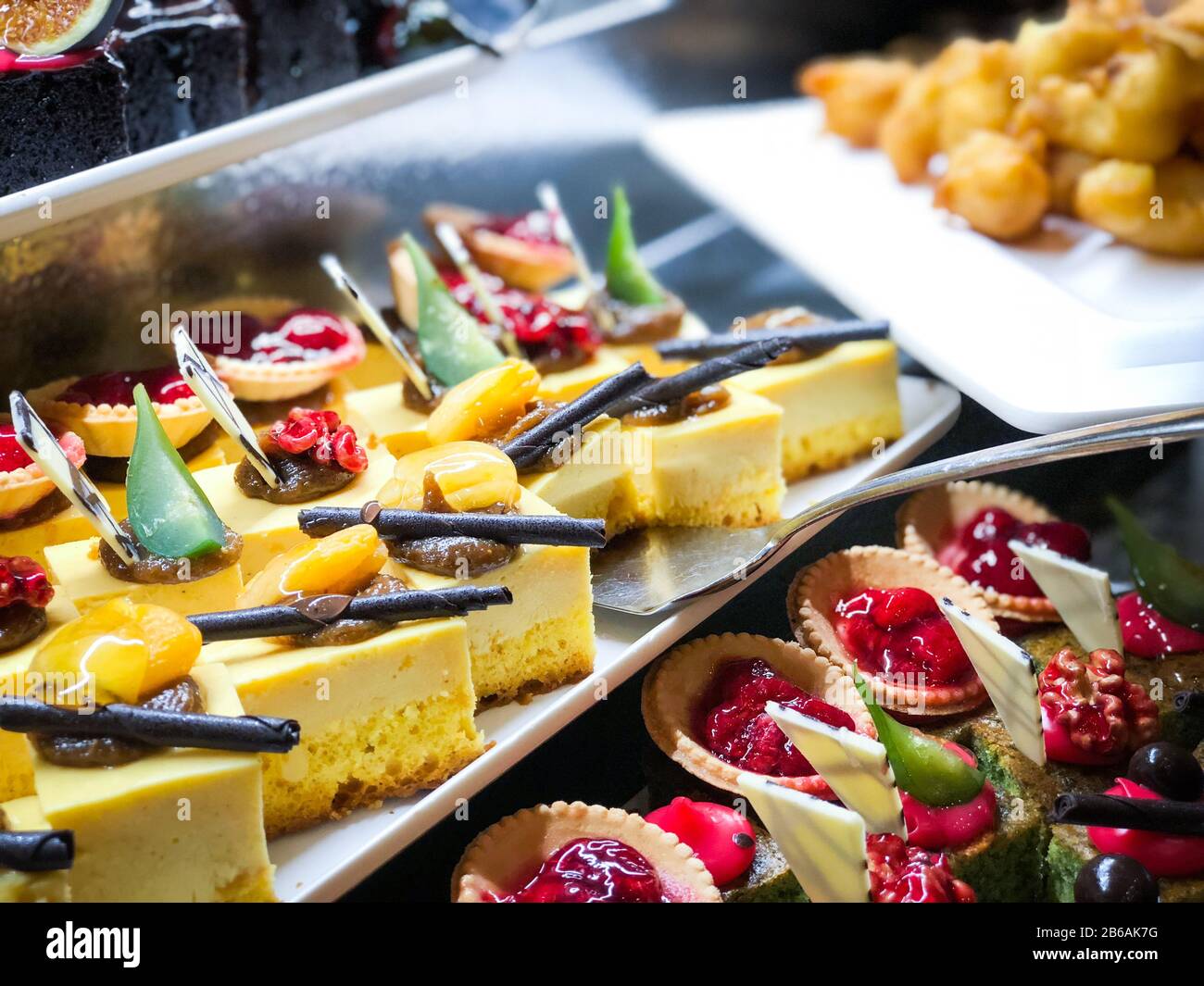 mix mini cakes & sweets with fresh fruits & glazed topping Stock Photo ...