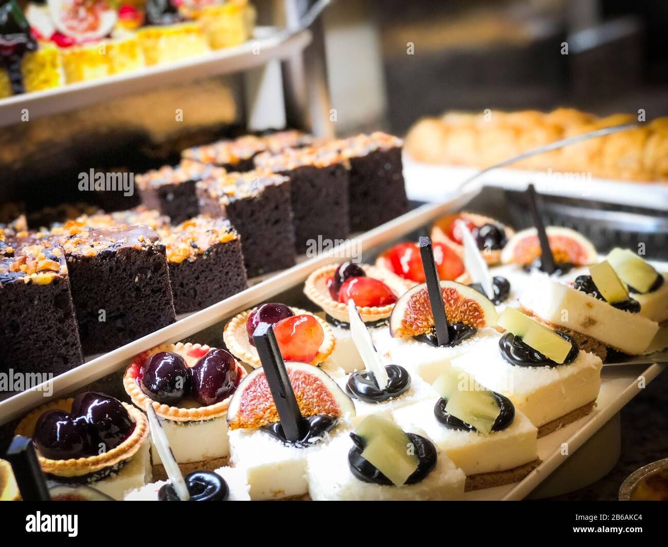 mix mini cakes & sweets with fresh fruits & glazed topping Stock Photo ...