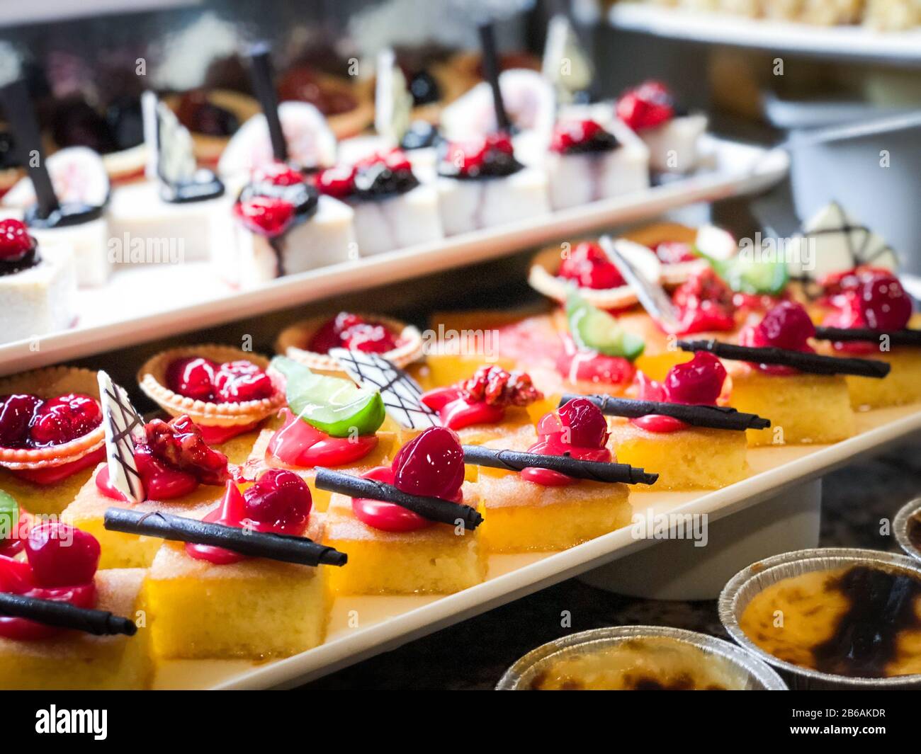 mix mini cakes & sweets with fresh fruits & glazed topping Stock Photo ...