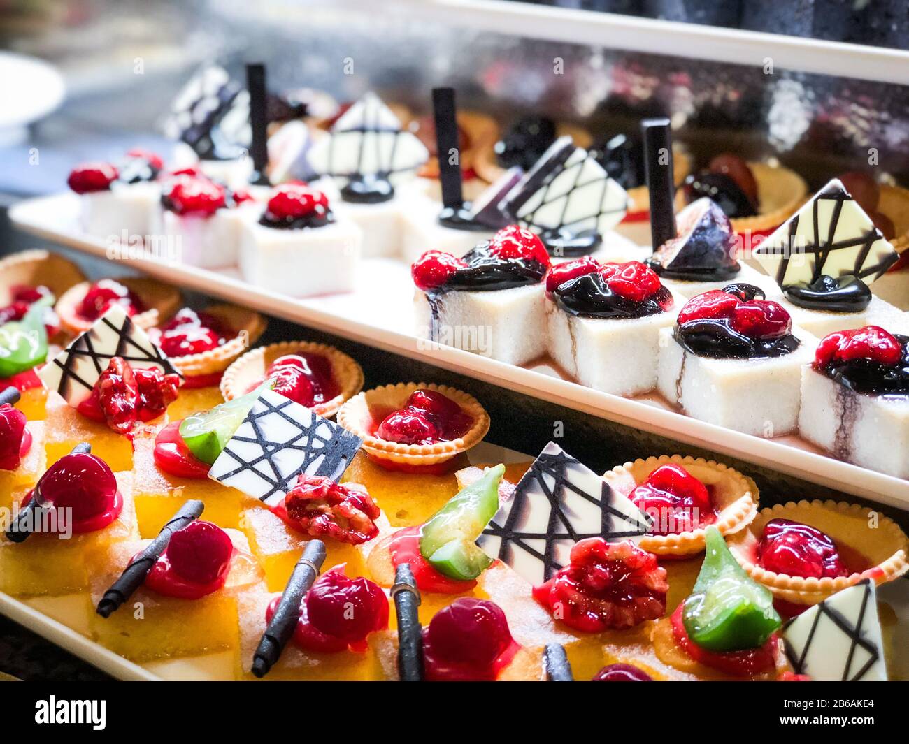 mix mini cakes & sweets with fresh fruits & glazed topping Stock Photo ...