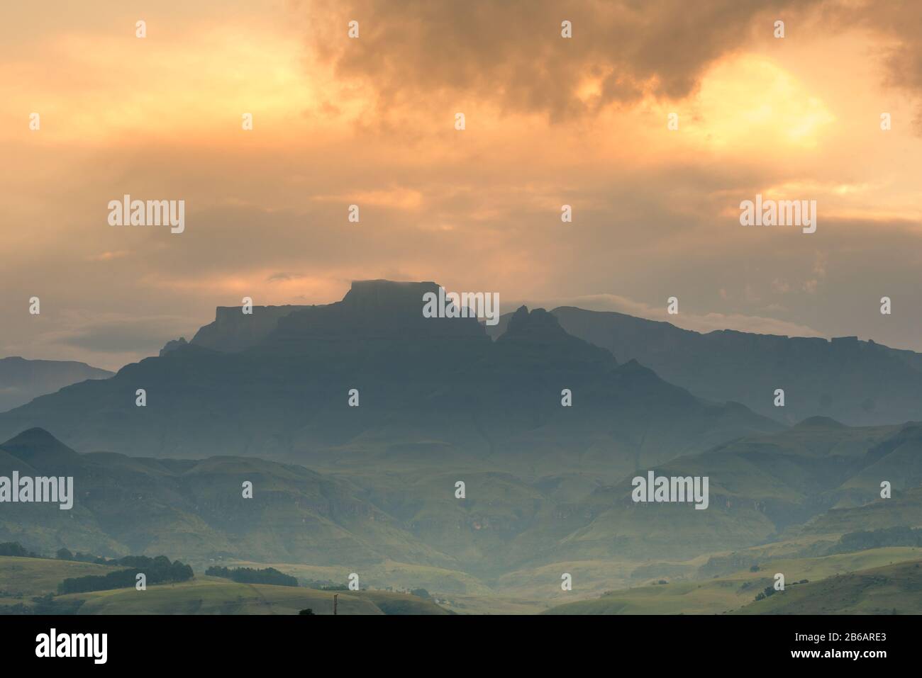 Champagne Castle mountain peak in shades of blue under a dramatic ...