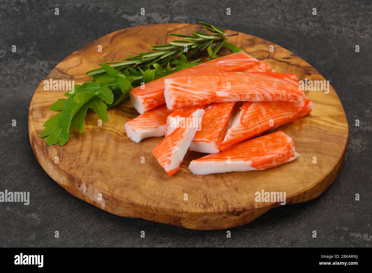 Crab stick surimi over wooden board Stock Photo - Alamy