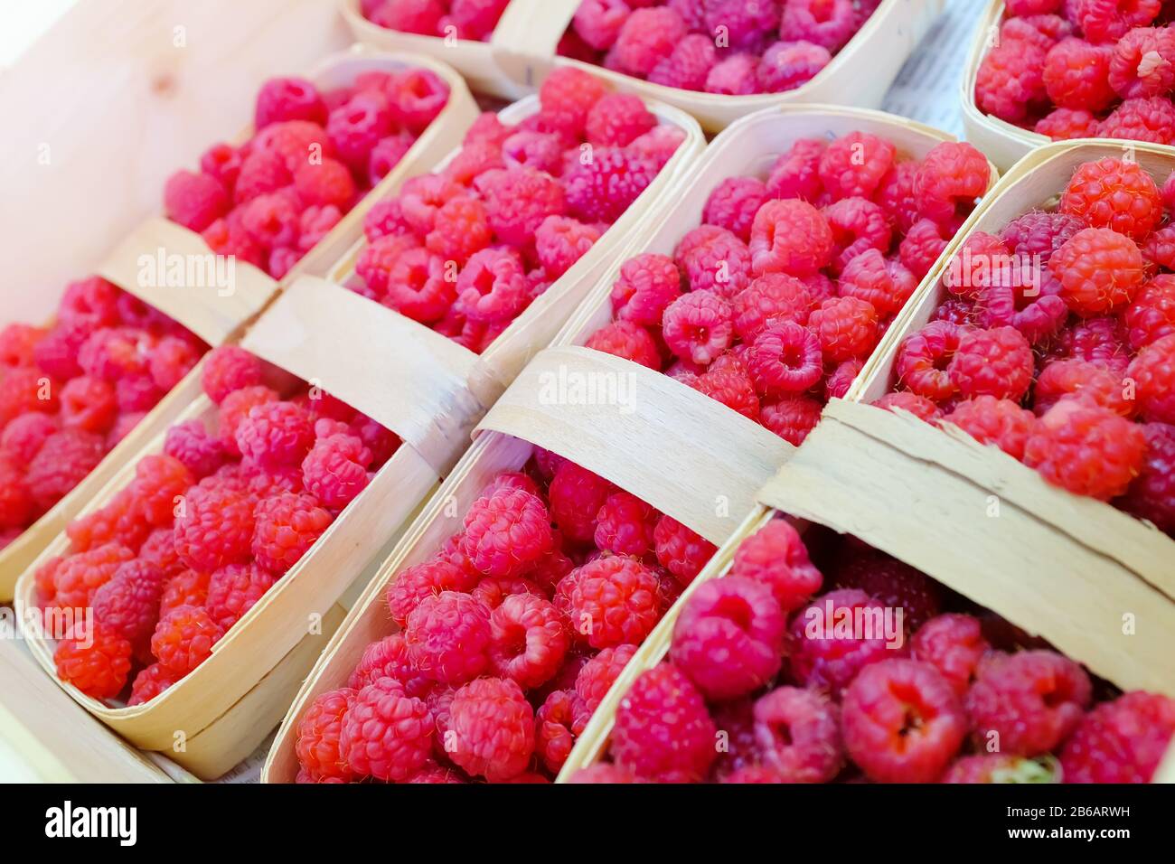 Fresh raspberries picked and in a wooden basket Stock Photo - Alamy