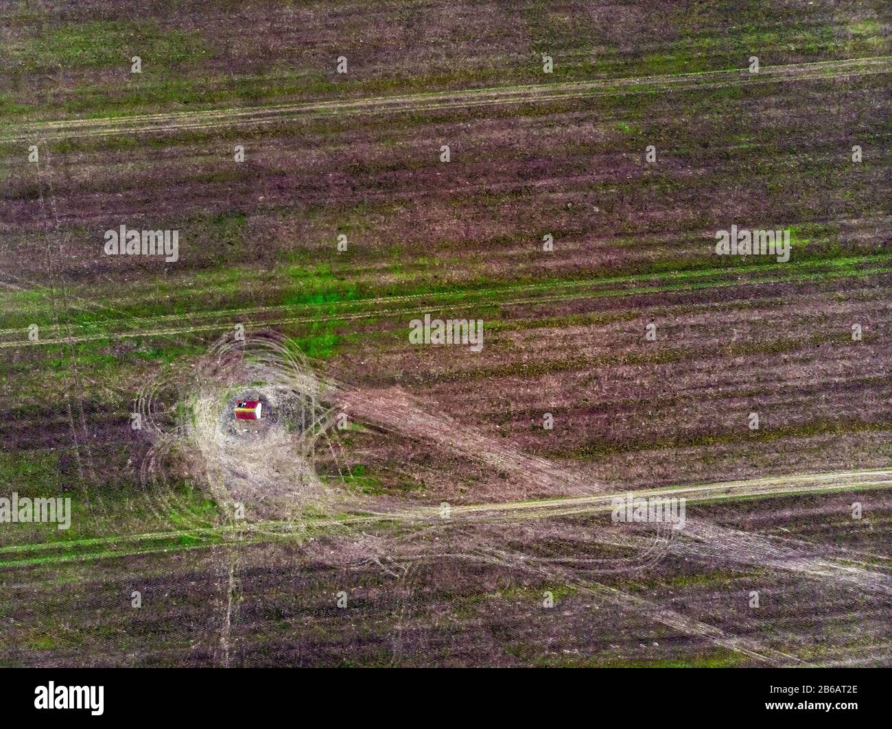 Top view of a farm field and a lone water supply farmhouse in the ...