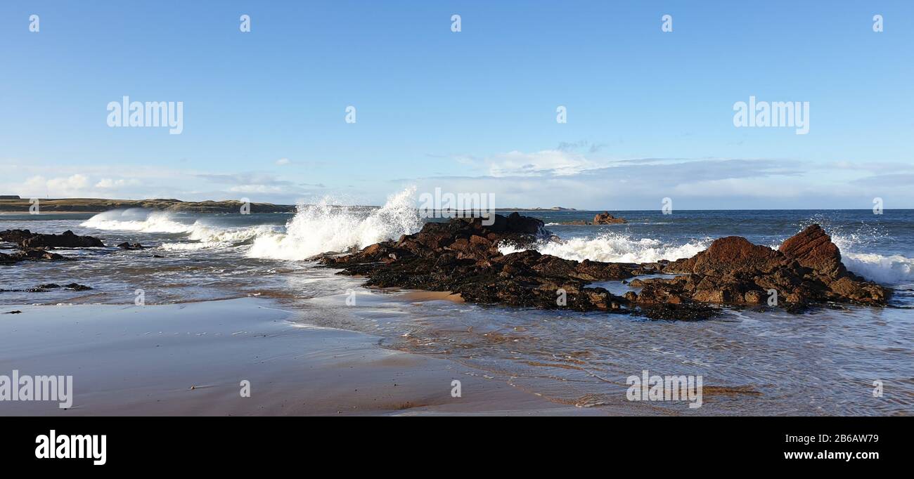 Waves hitting rocks Stock Photo - Alamy