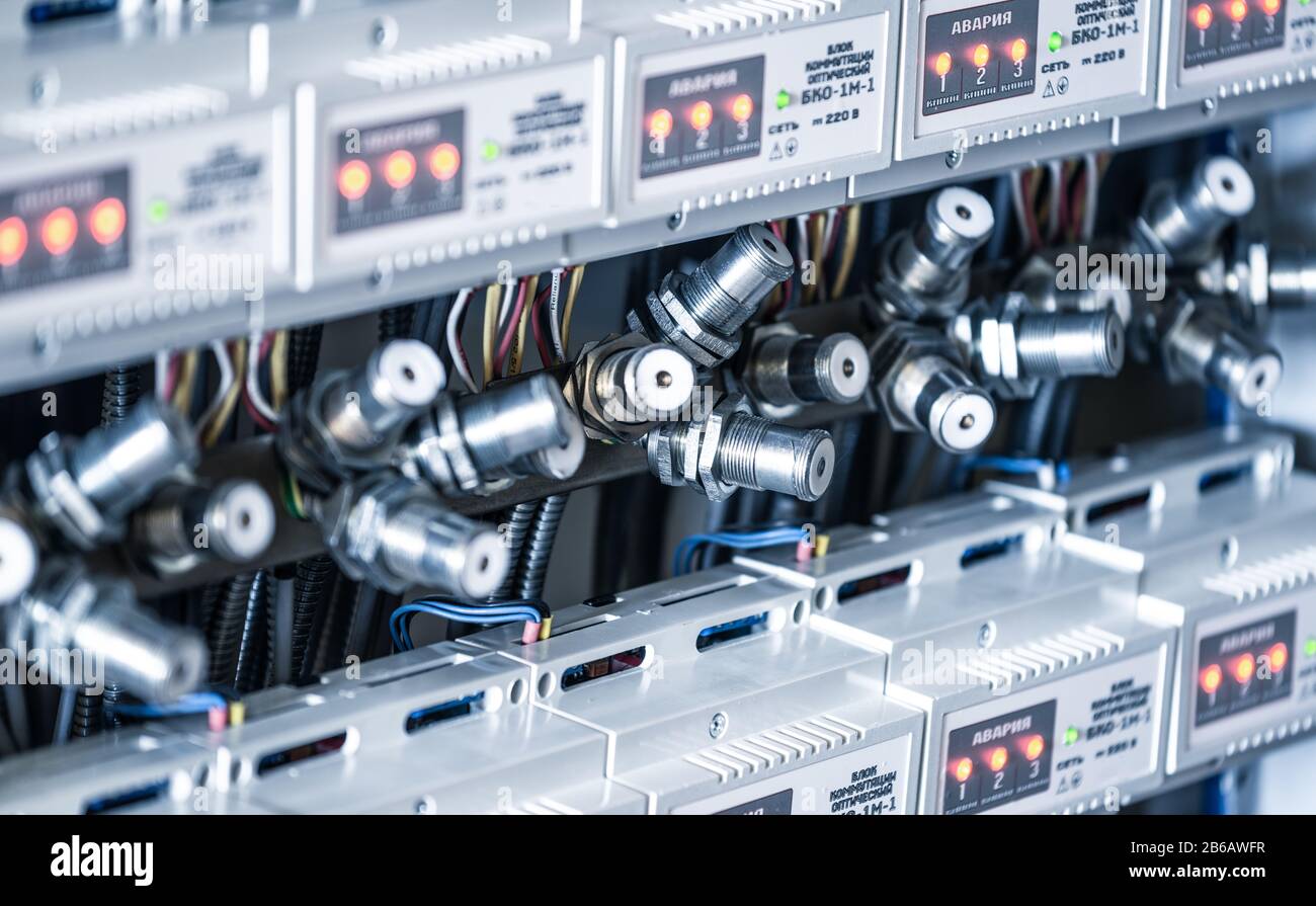 Close-up numerous metal plugs hang next to instrument panels at a ...