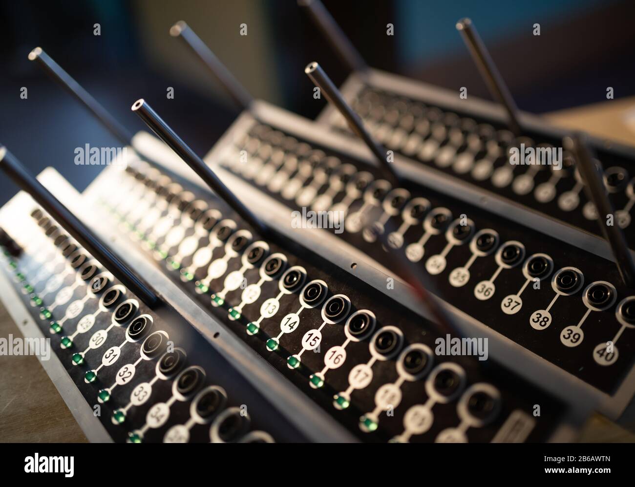 Close-up panel with numbered round buttons and inputs with plugs next ...