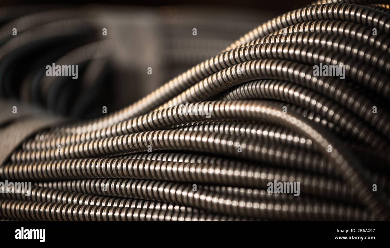 Close-up of a huge golden bundle of metal flexible tubes interconnected ...