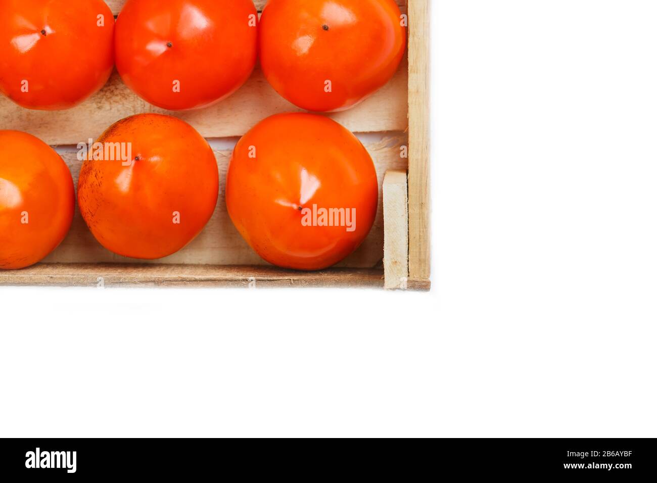 Persimmon fruit in the wooden box isolated on white. Clipping Path ...