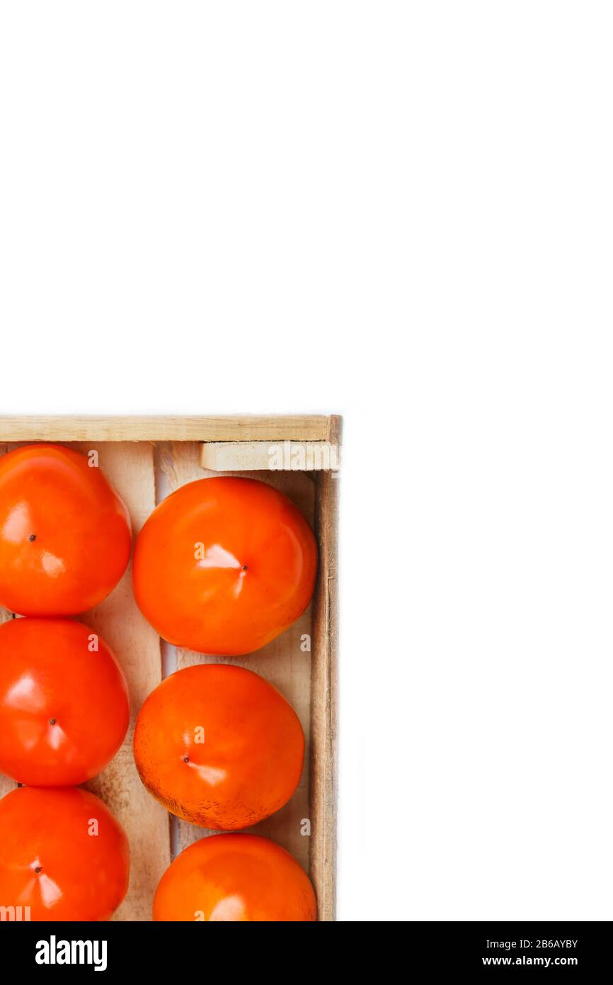 Persimmon fruit in the wooden box isolated on white. Clipping Path ...