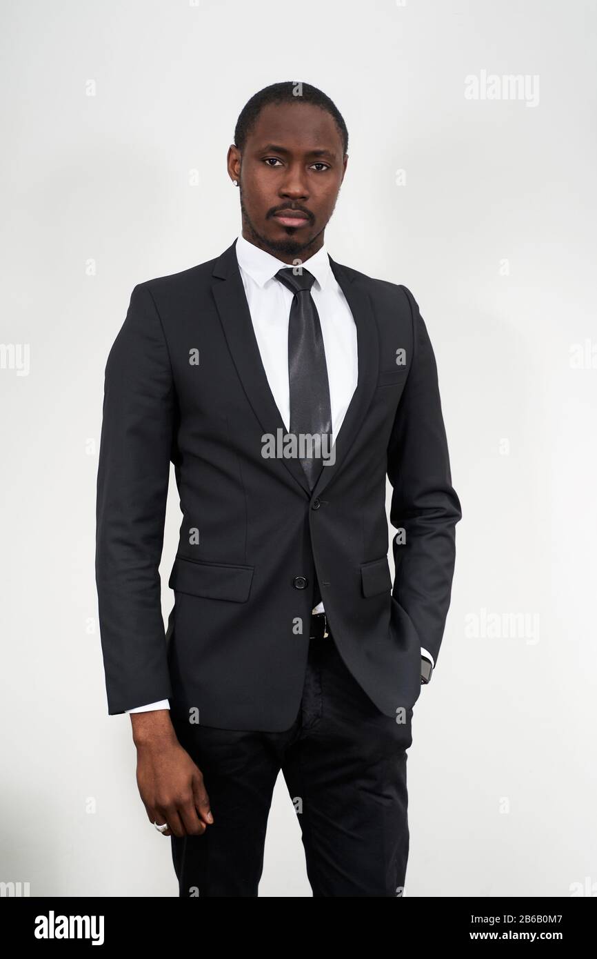 serious african american businessman wearing black suit over grey ...