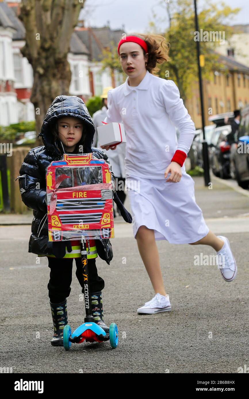 An Orthodox Jewish girl in a costume poses for the camera during the ...