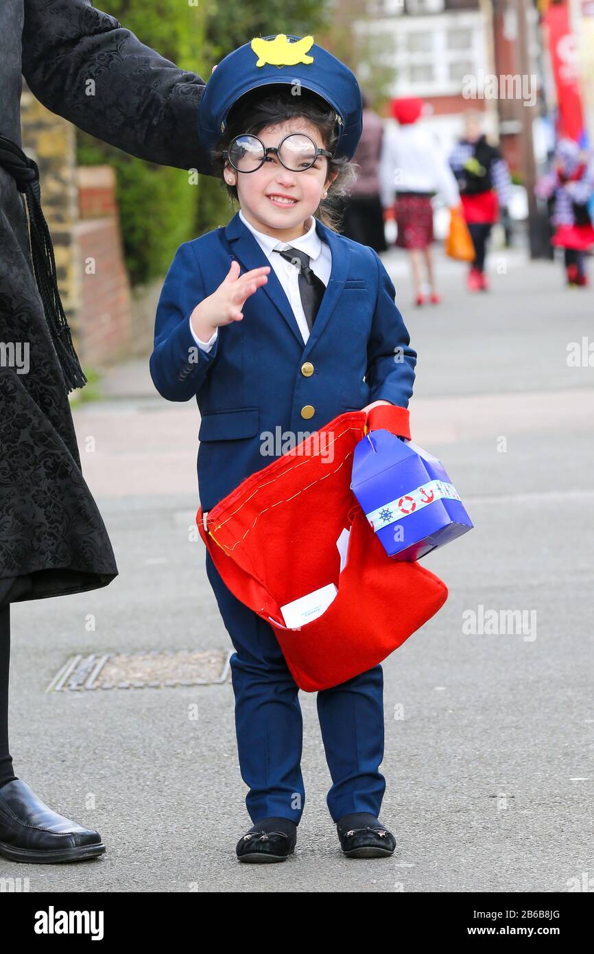 An Orthodox Jewish child in a fancy costume during the event.Members of ...