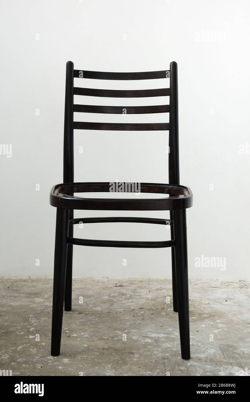 The framework of an old wooden chair after cleaning and a covering is ...