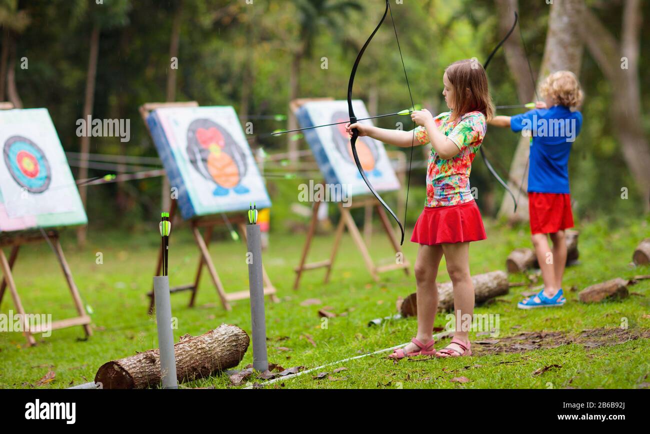 Archery for child. Little girl with bow and arrow. Kids shoot on ...