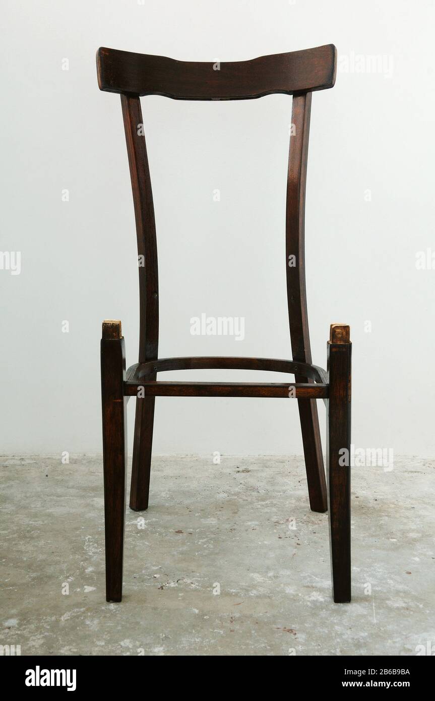 The framework of an old wooden chair after cleaning and a covering is ...