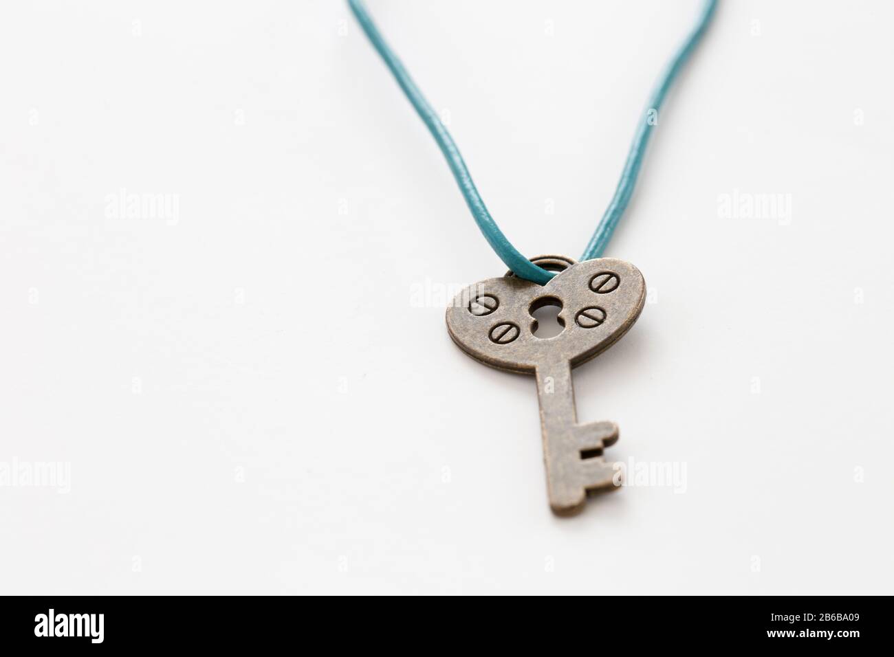 key necklace with blue strap on white background Stock Photo - Alamy