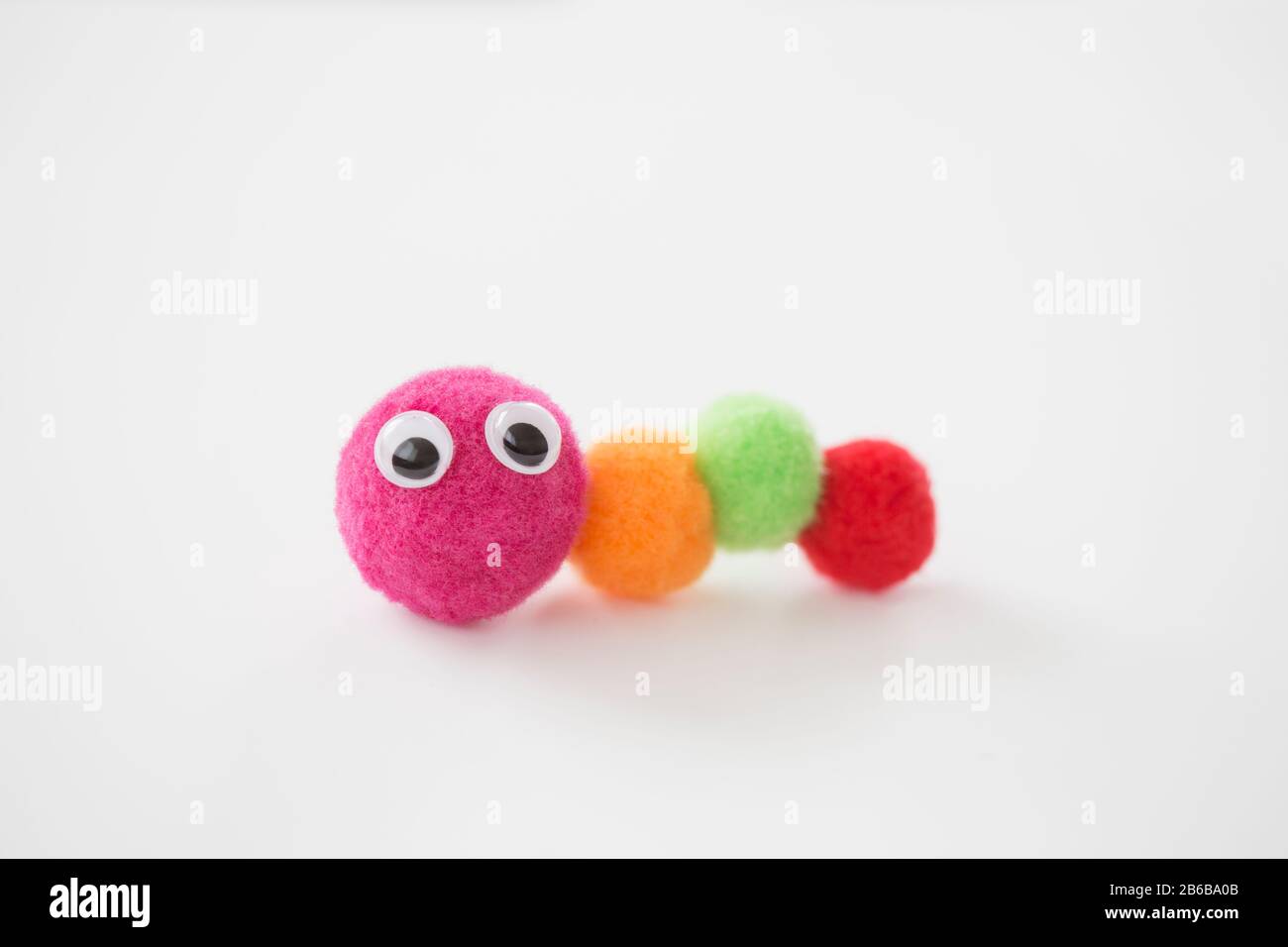 colorful pom pom bug on white background Stock Photo - Alamy