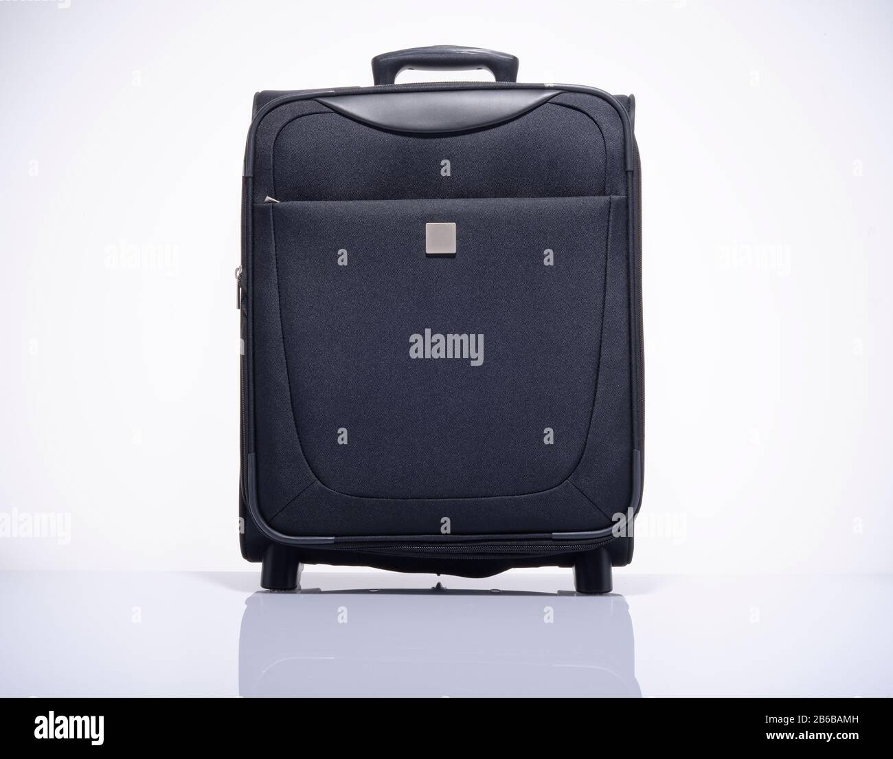 A black suitcase with two wheels and a pulling handle Stock Photo - Alamy