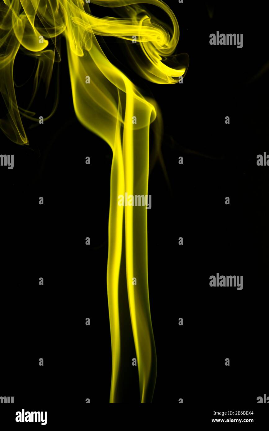 Abstract shape of yellow smoke on black background Stock Photo - Alamy