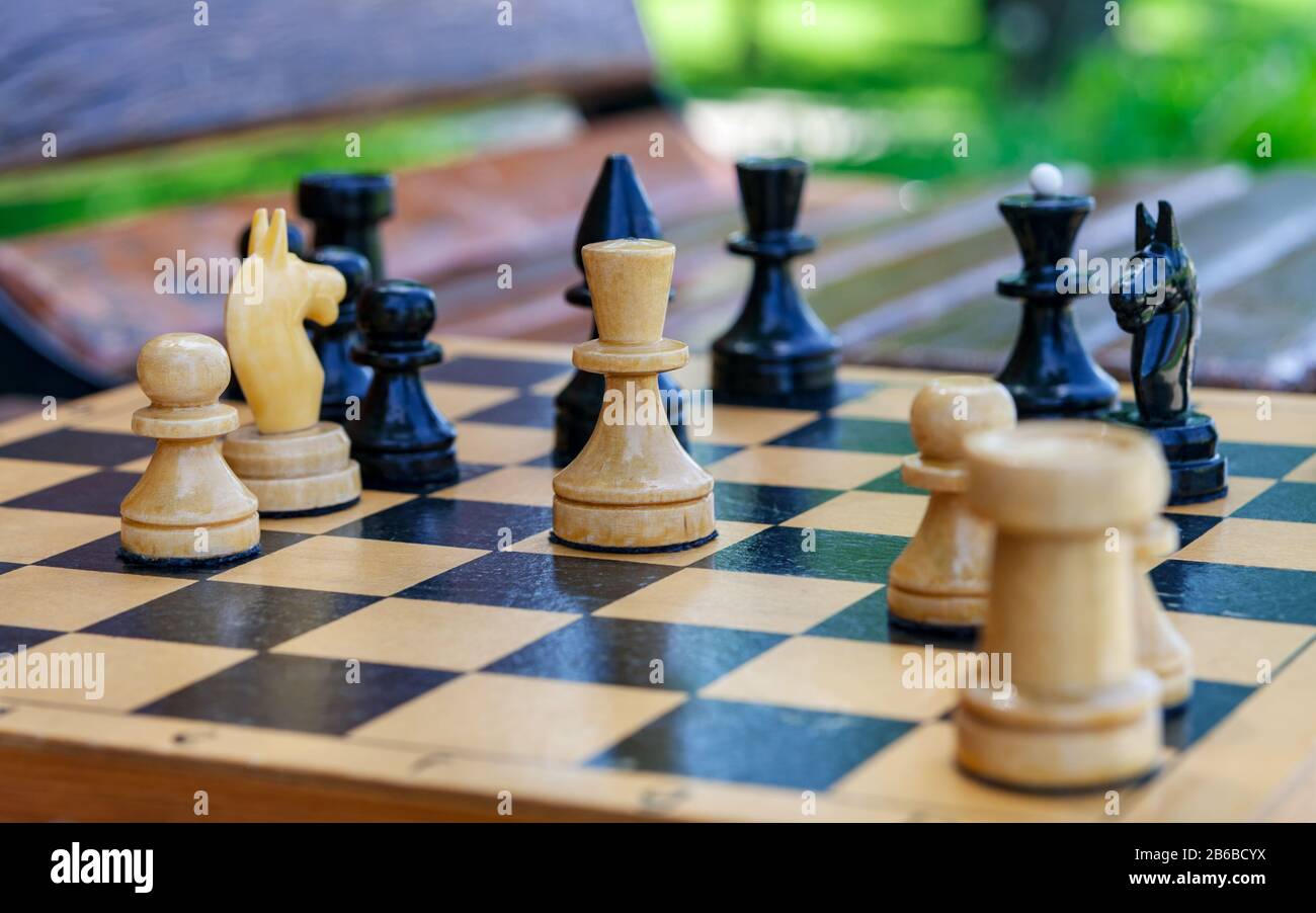 Wooden chess on the bench in a park Stock Photo - Alamy