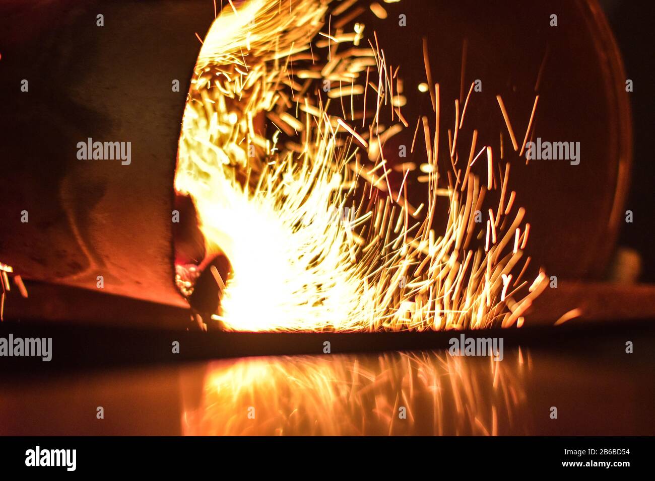 spark explosion from pouring coals into grill on dark evening Stock ...