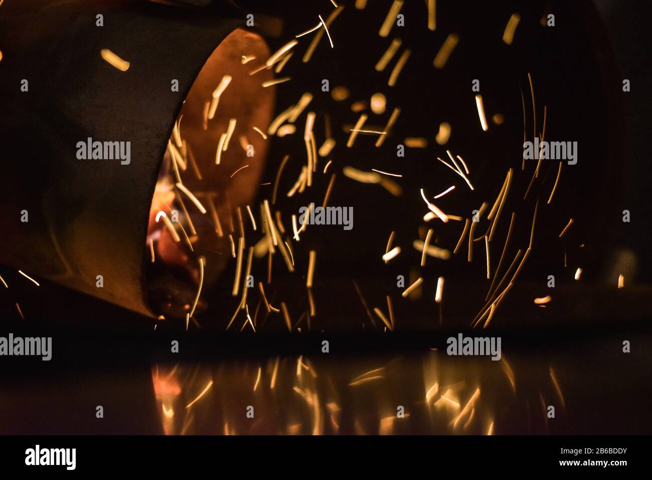 sparks floating from BBQ starter on dark evening Stock Photo - Alamy