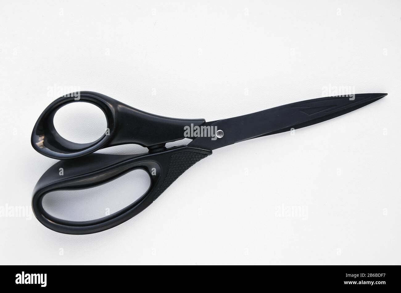 Scissors cutting black fabric hi-res stock photography and images - Alamy