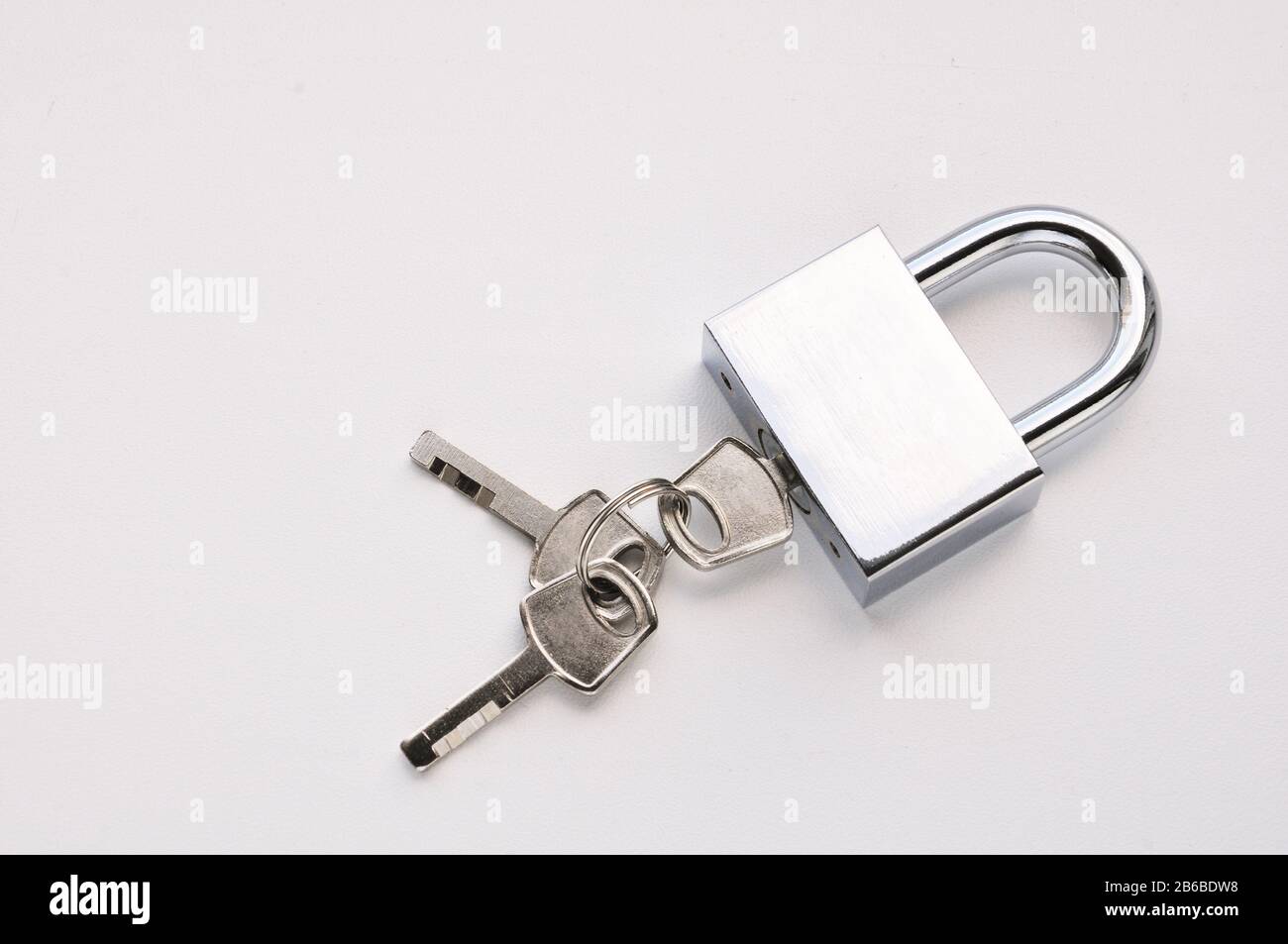 Locked silver lock with three keys on a white background Stock Photo ...