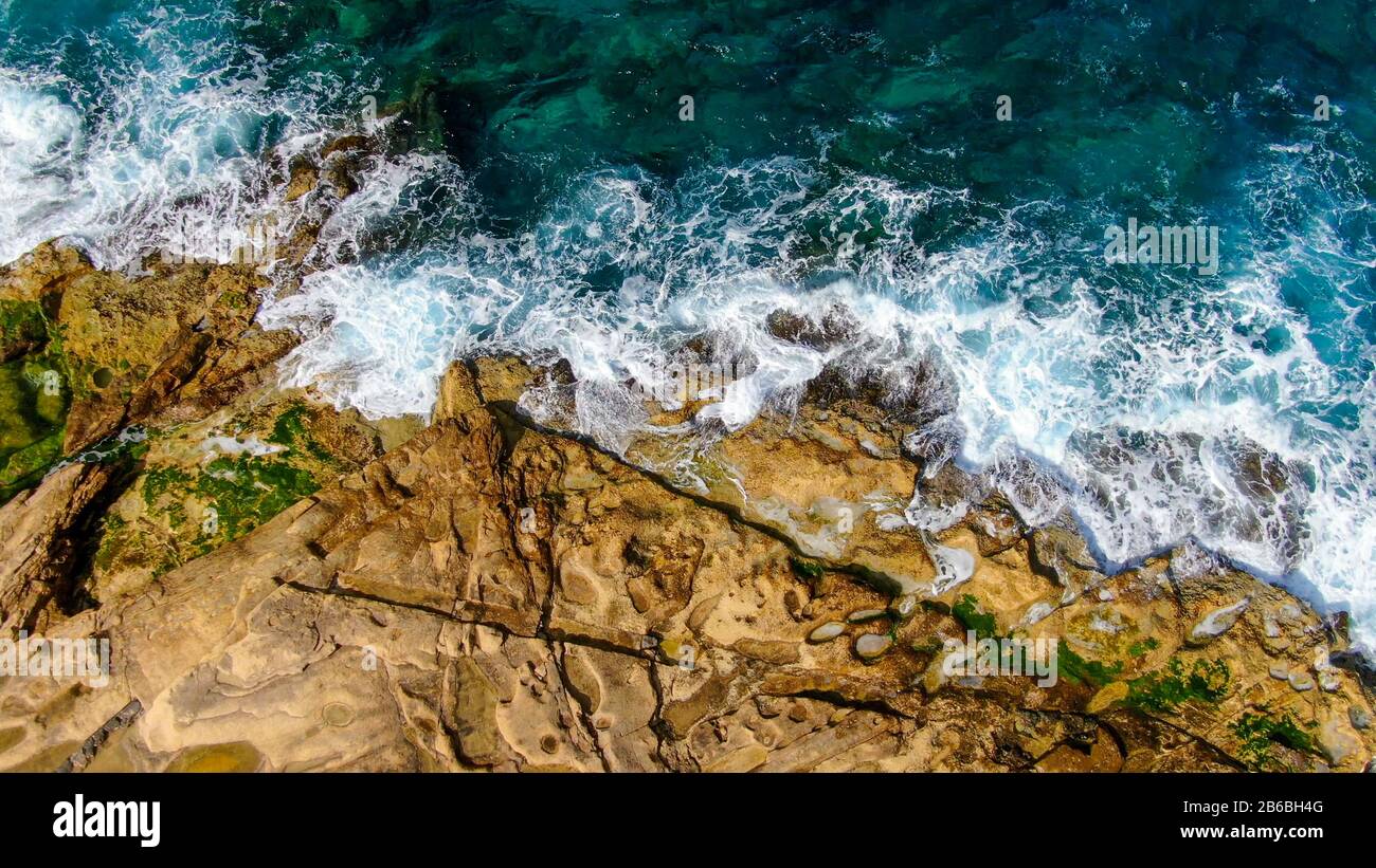 Wild Ocean water from above - Waves hitting the rocks Stock Photo - Alamy