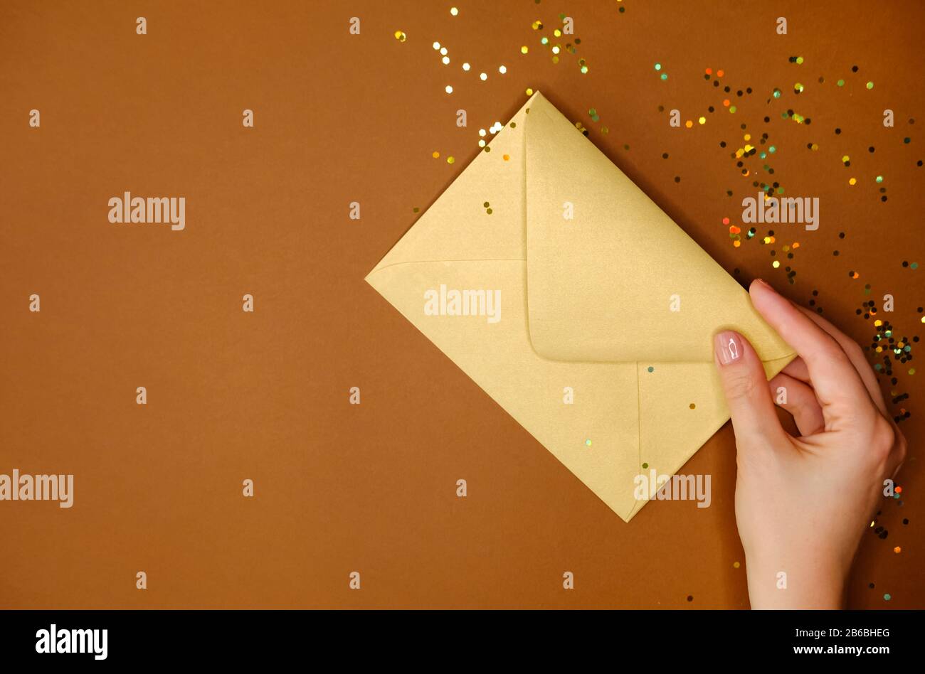 Envelope in hand Stock Photo - Alamy