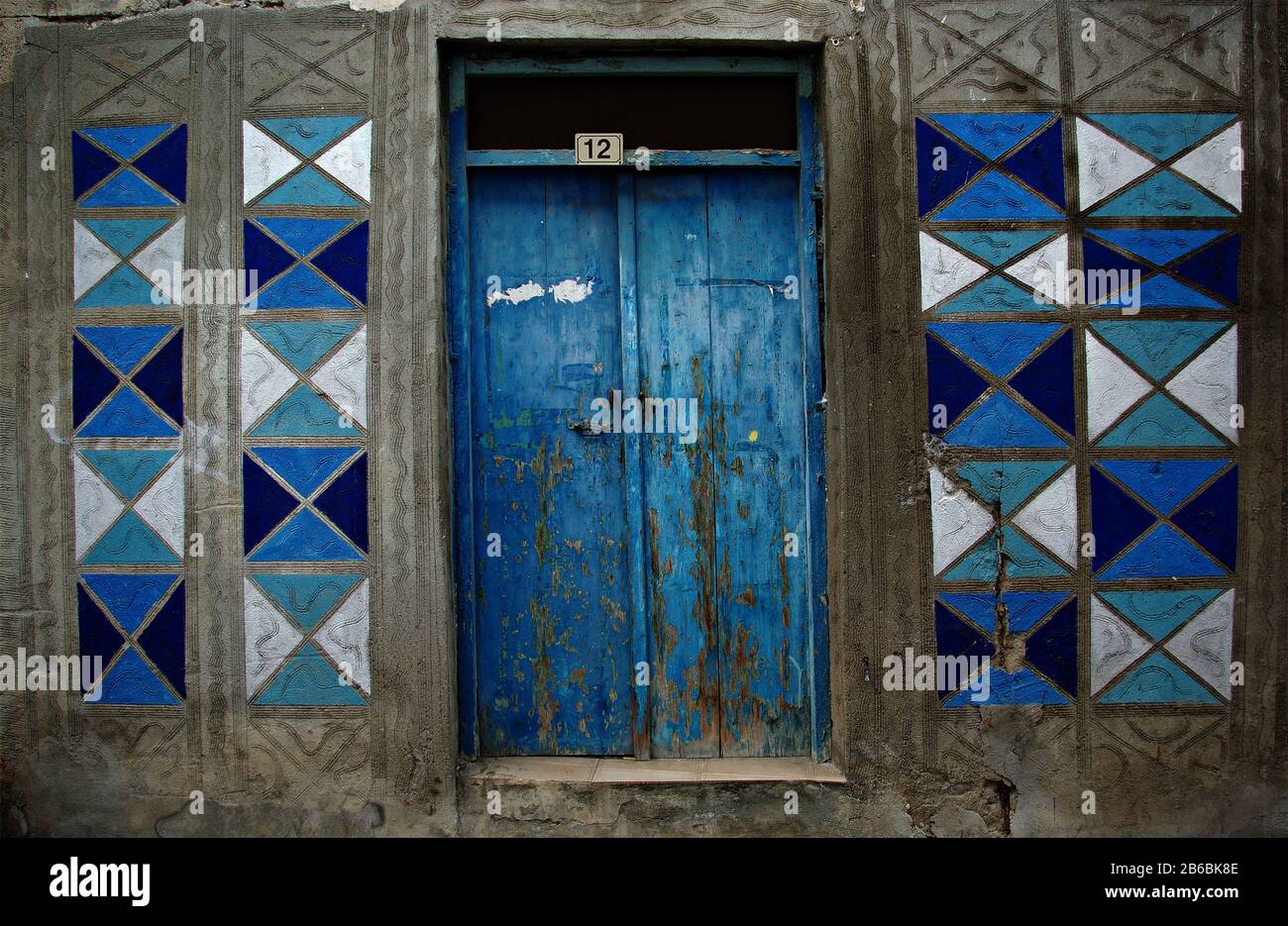 Blue entrance door with blue shaded square ornaments Stock Photo - Alamy