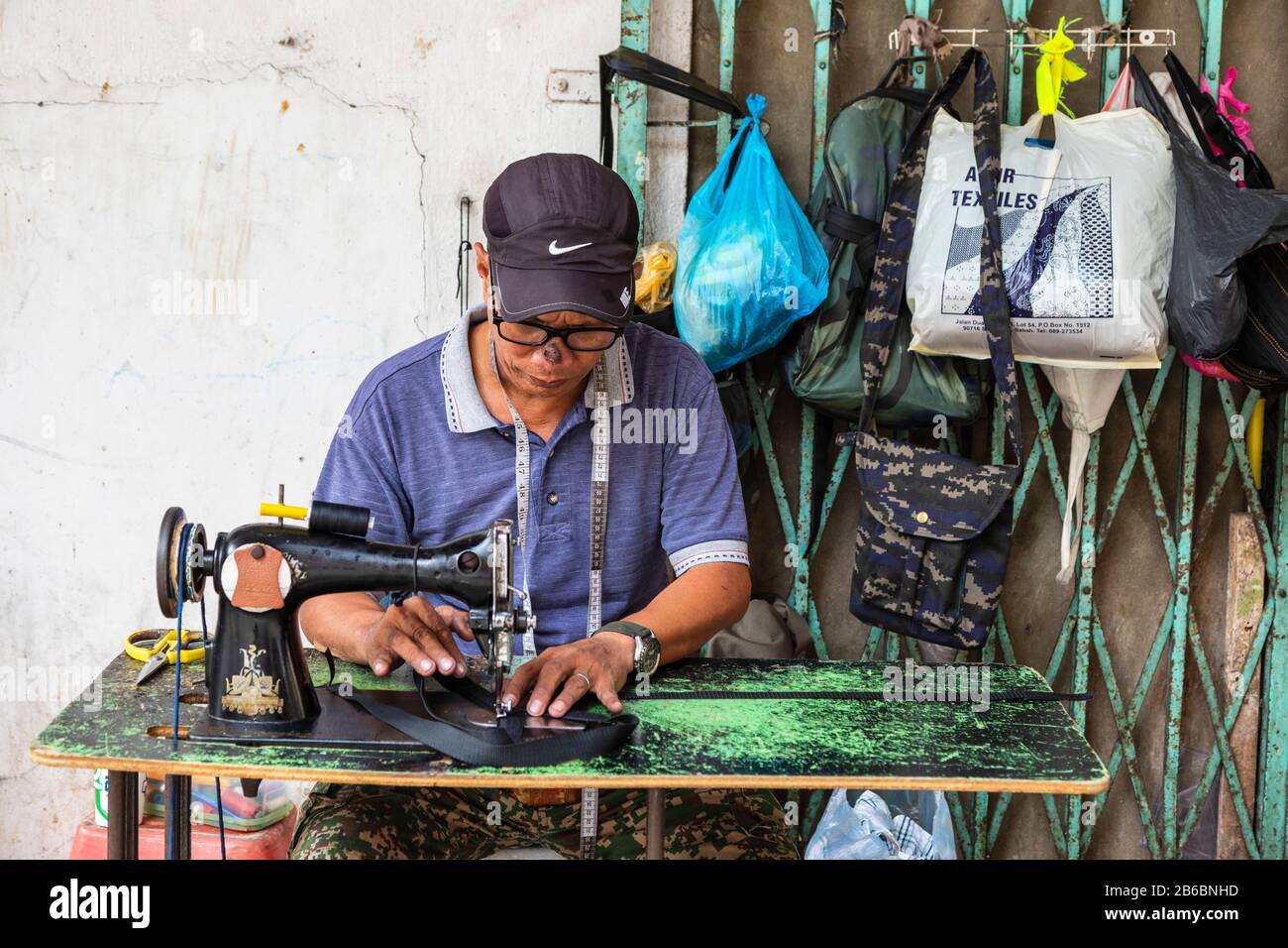 Man sewing hi-res stock photography and images - Alamy