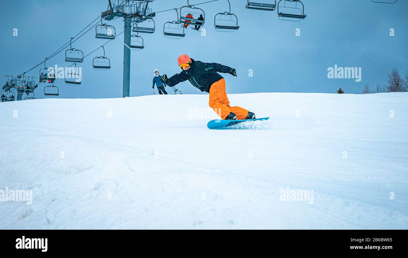 Snowboarder going down ski slope hi-res stock photography and images ...
