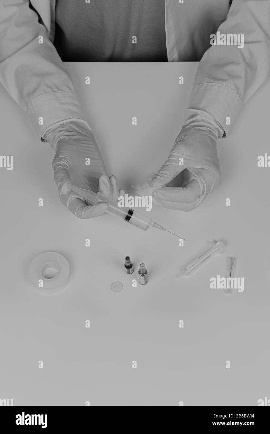 MD preparing injection, faded monochrome style. Top view of medical ...