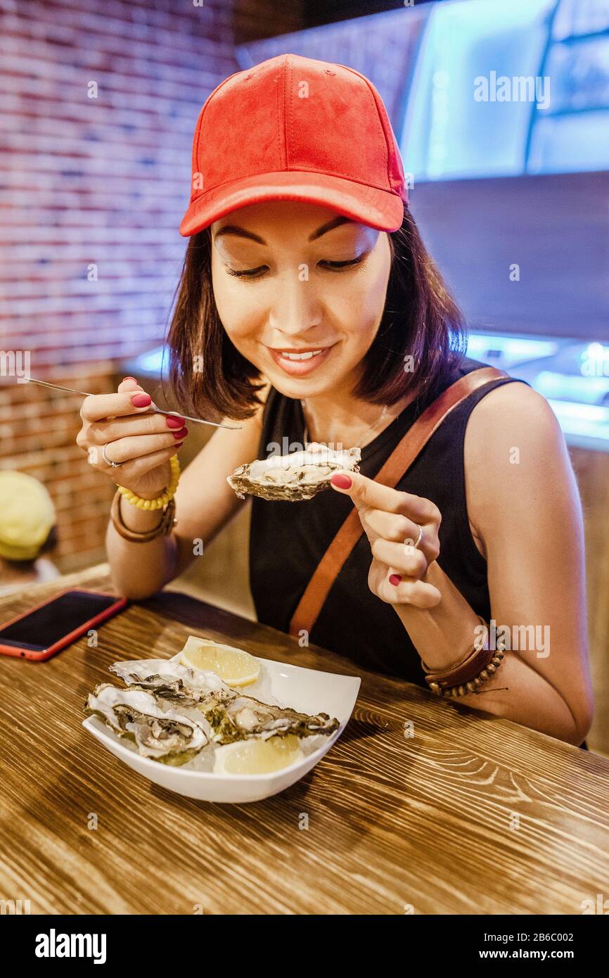 Beautiful young woman eat oyster hi-res stock photography and images ...