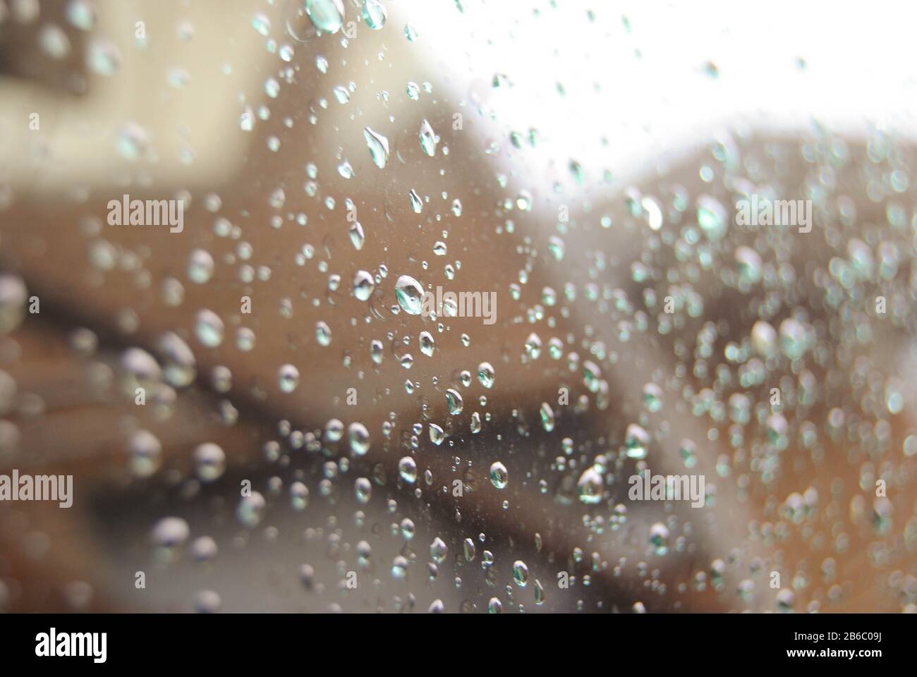 Rain Droplets On Reflective Window Stock Photo - Alamy
