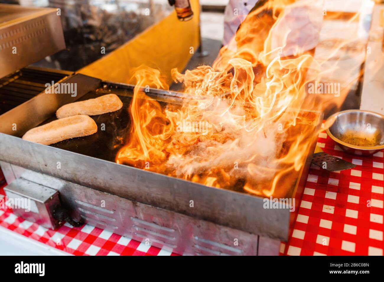 chef prepare food with flames of open fire Stock Photo - Alamy