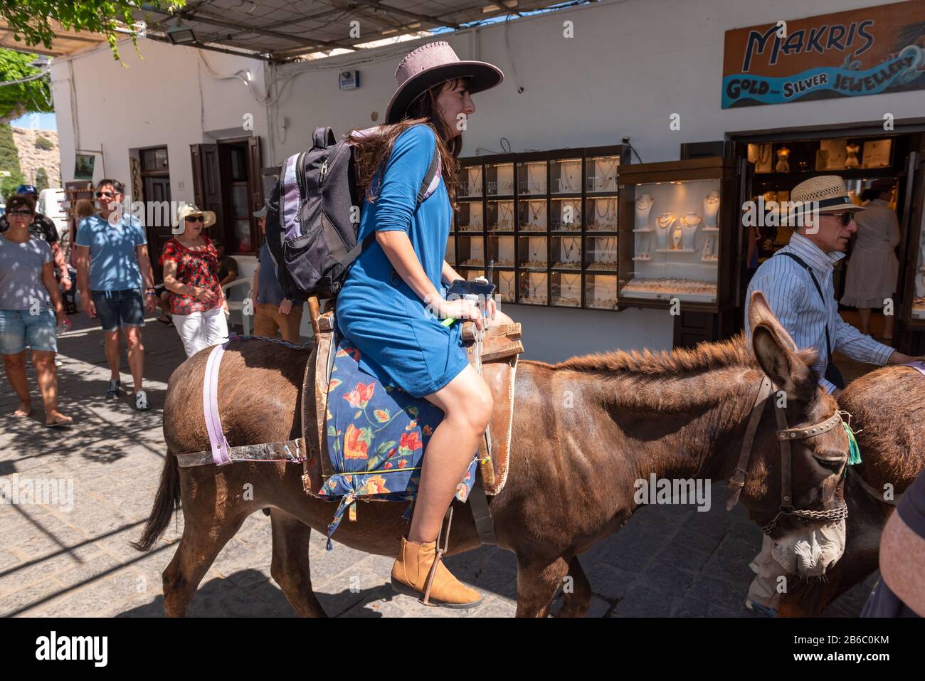 Rhodes, Greece - May 14, 2018: Woman riding donkey. Using donkey taxi ...